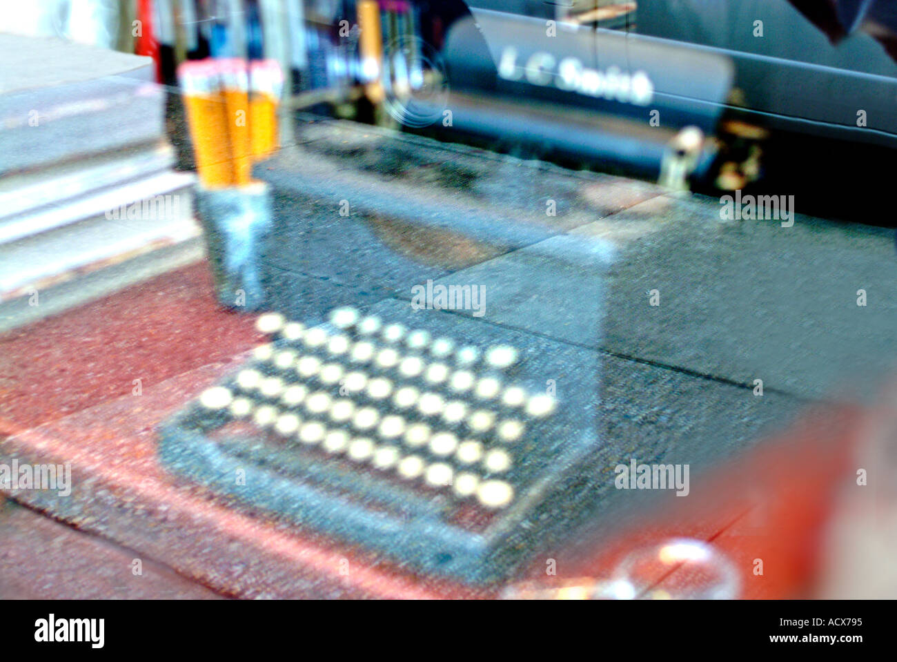 View of antique typewriter on wooden office desk through glass ...