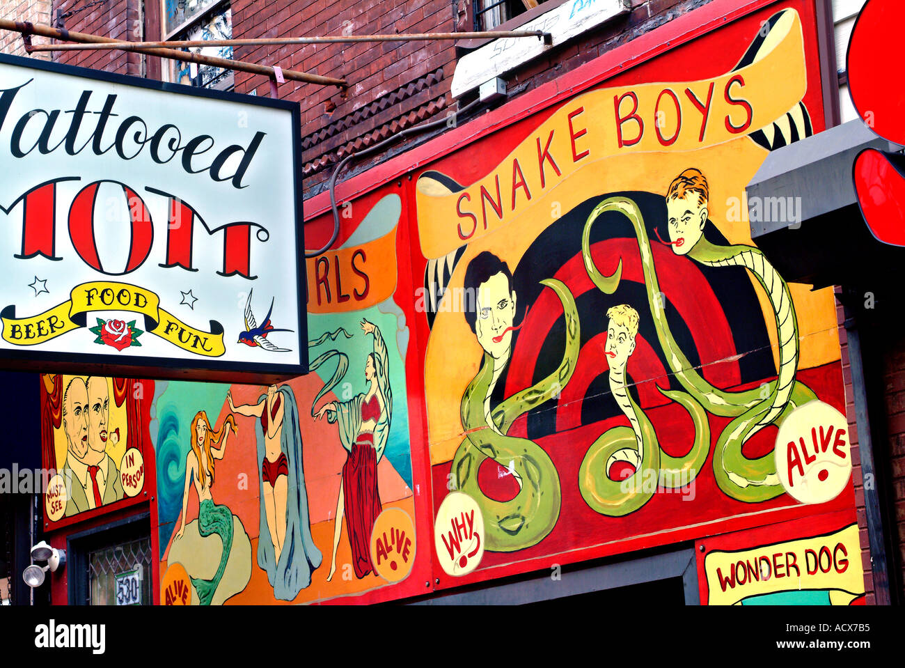 Graphic colorful advertising sign for tattoo parlor Stock Photo - Alamy