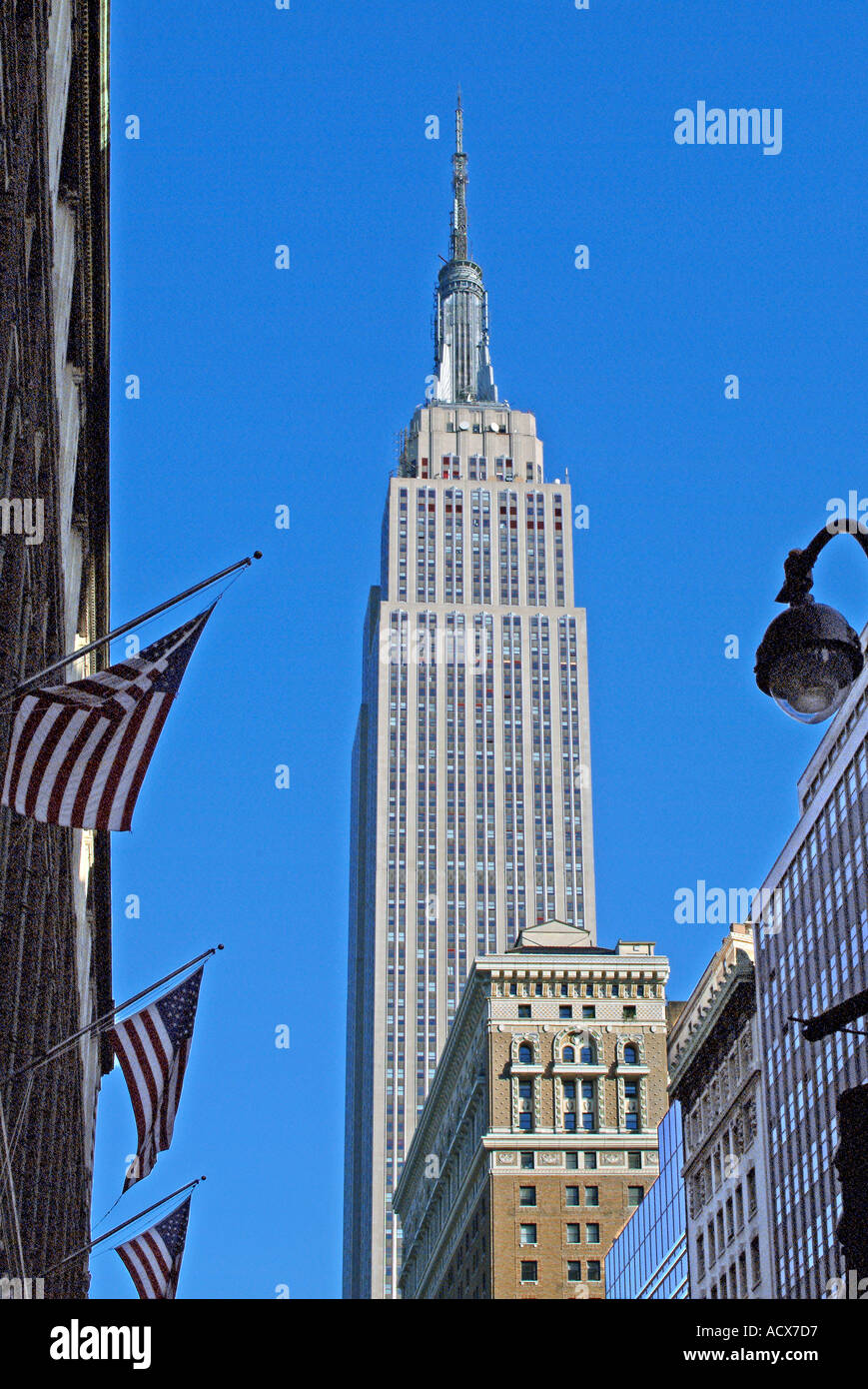 Empire State Building with flags in downtown Manhattan New York City ...