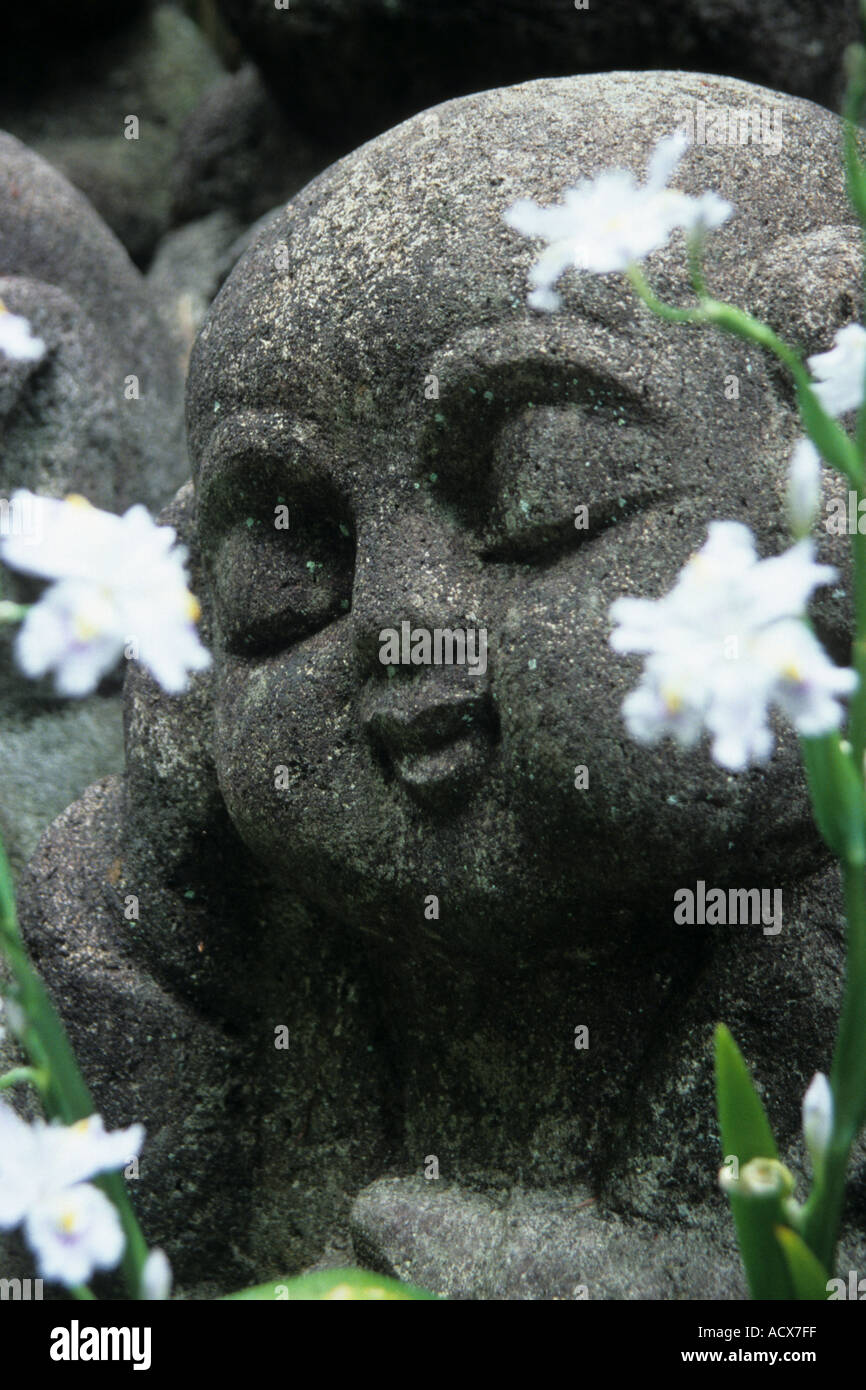 Stone statue of child sleeping Japan Stock Photo - Alamy