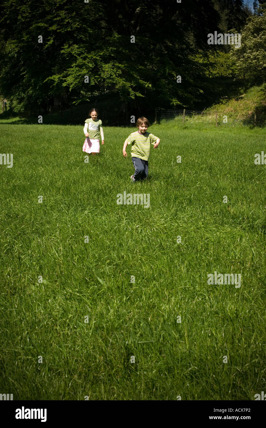 Children Running Through Meadow Stock Photos & Children Running Through ...