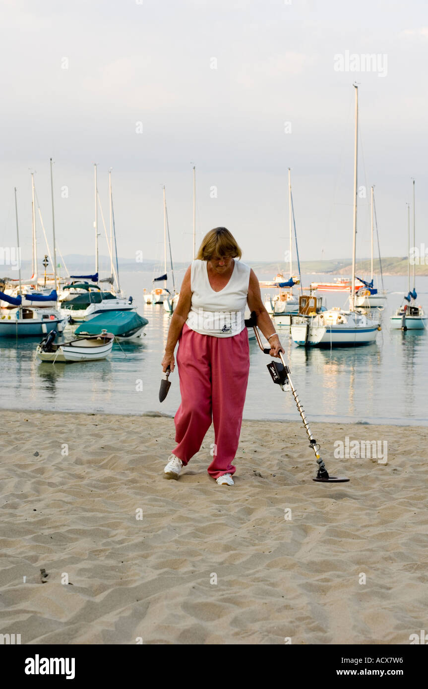 woman metal detectorist on beach at New Quay Ceredigion Wales UK in the ...