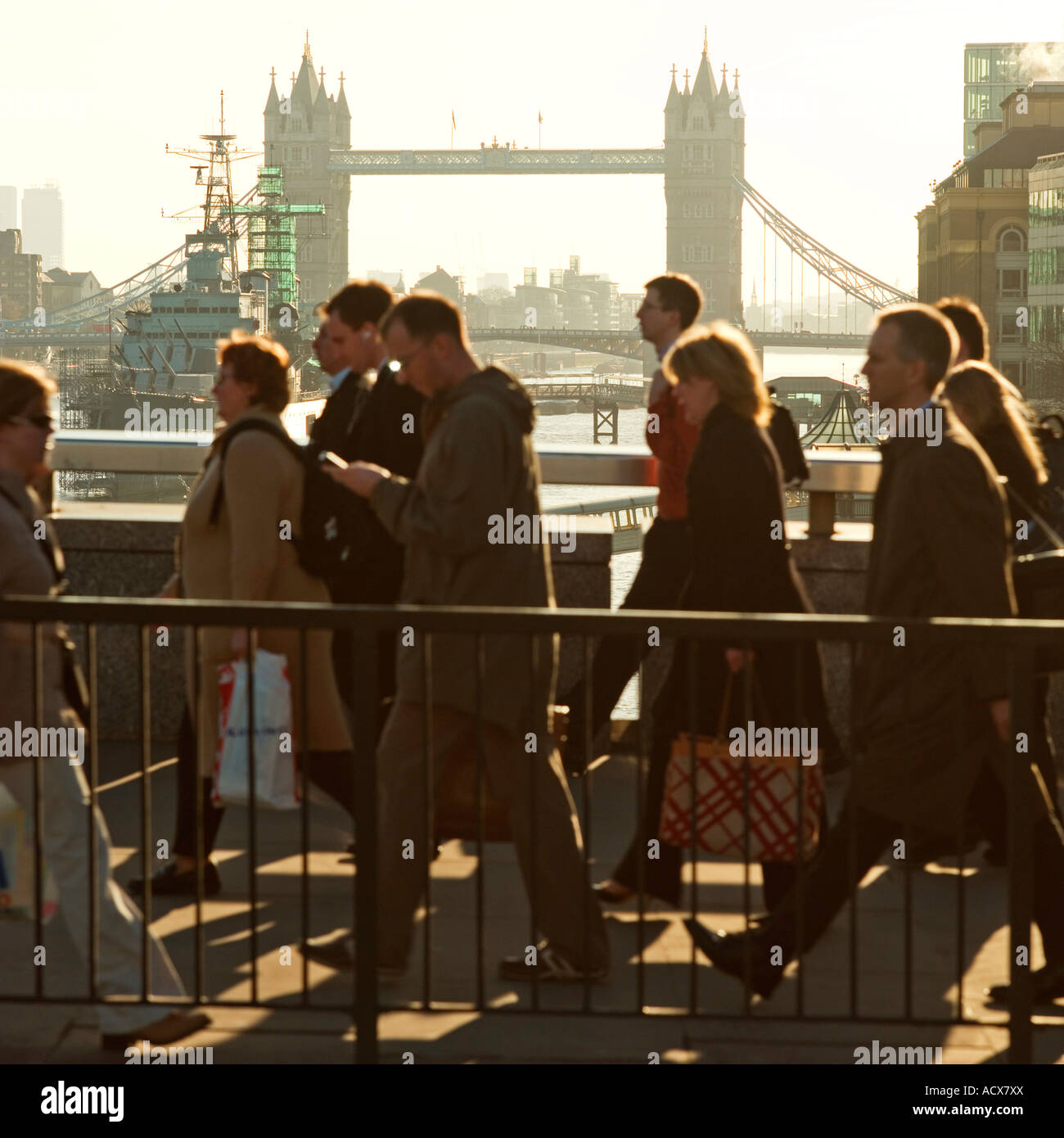 Going to work early morning office workers walking over London Bridge ...