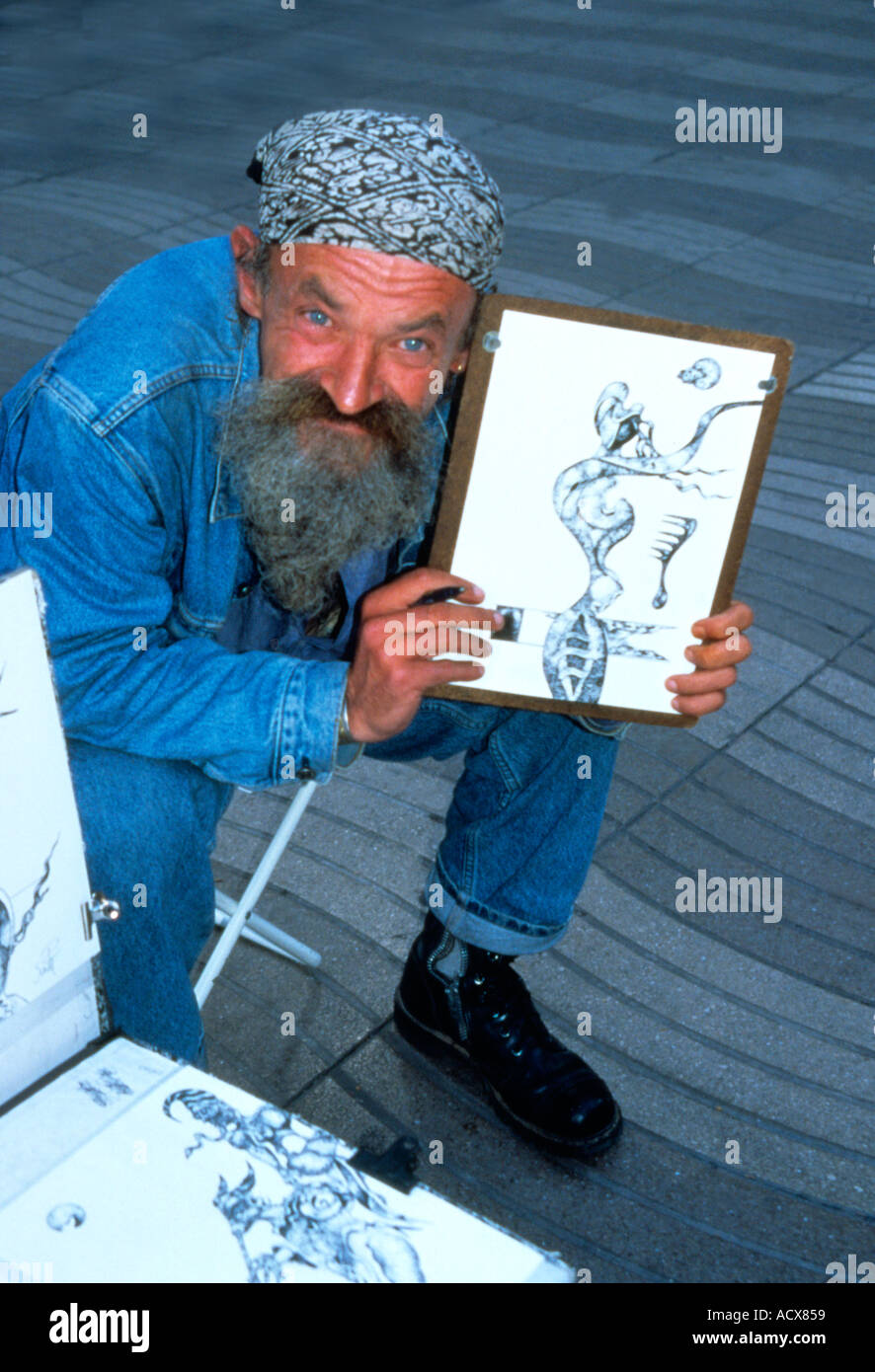 Local street artist shows his drawing to tourists in Las Ramblas In ...