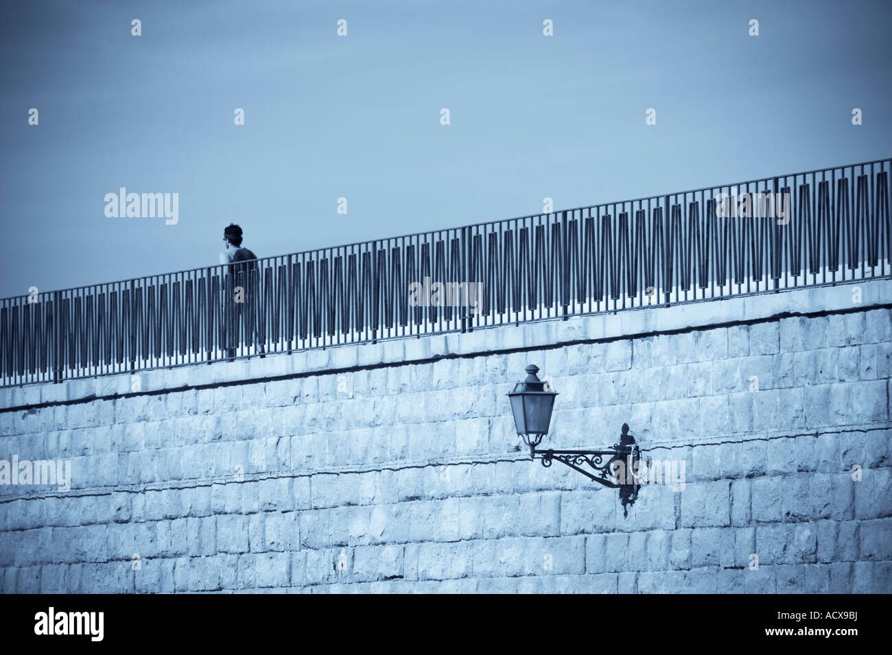 Man walking along embankment Stock Photo - Alamy