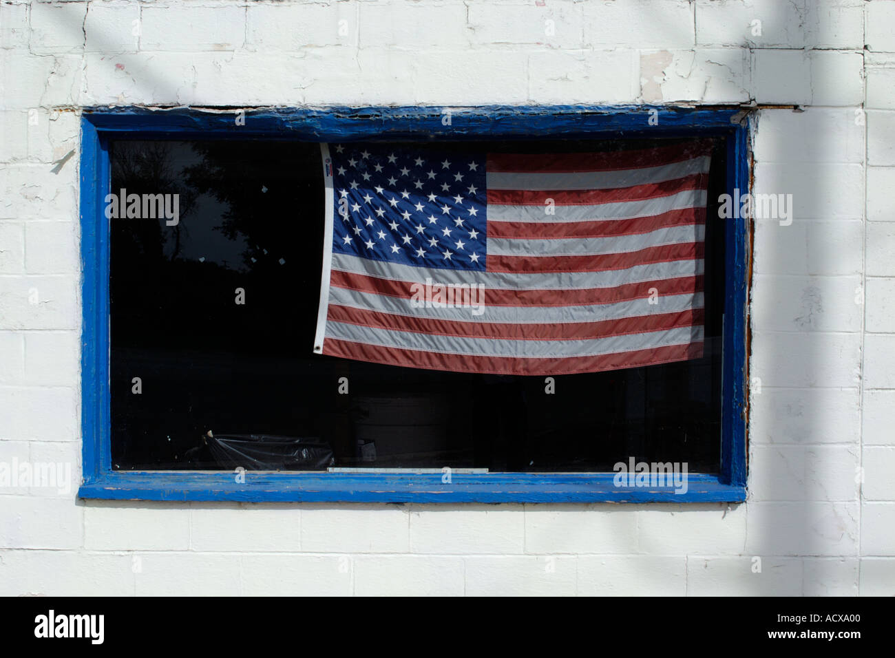 American flag hanging in window Stock Photo - Alamy