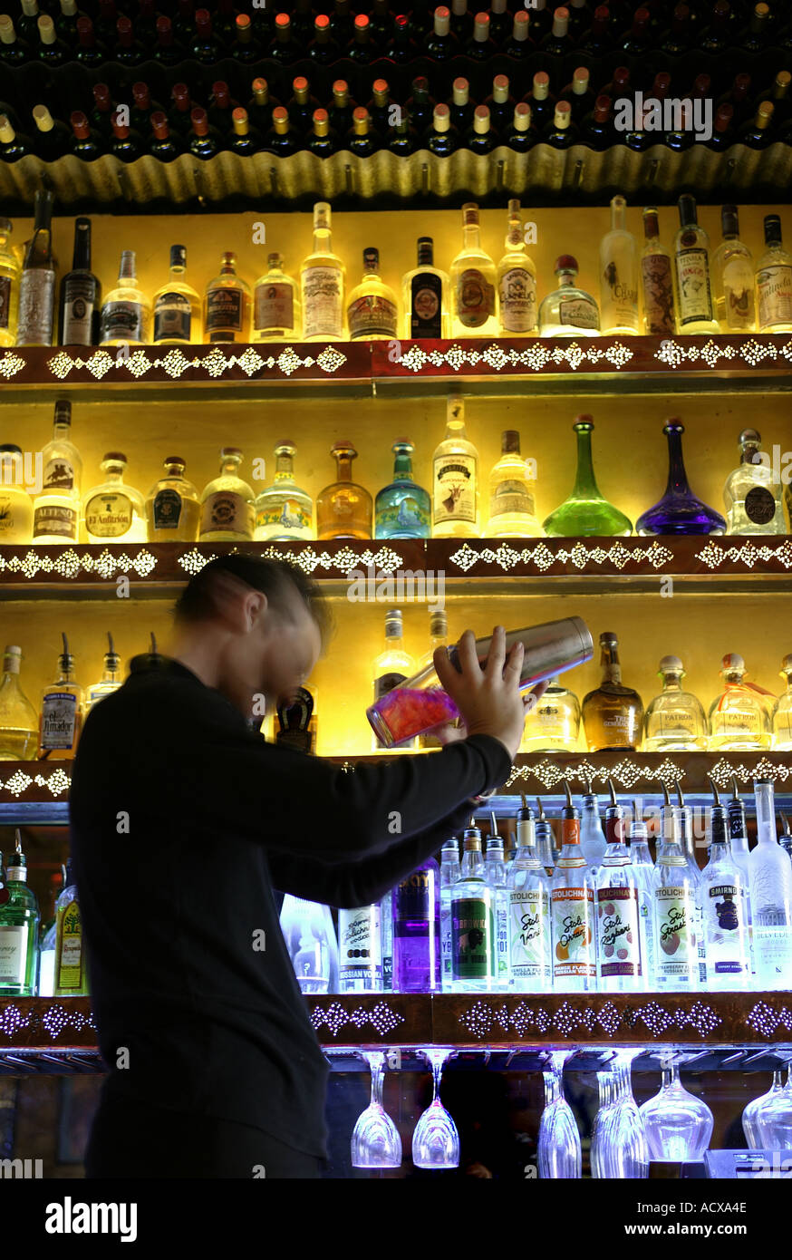 Cocktail barmen shaking a cocktail drink Bottles behind bar Stock Photo ...