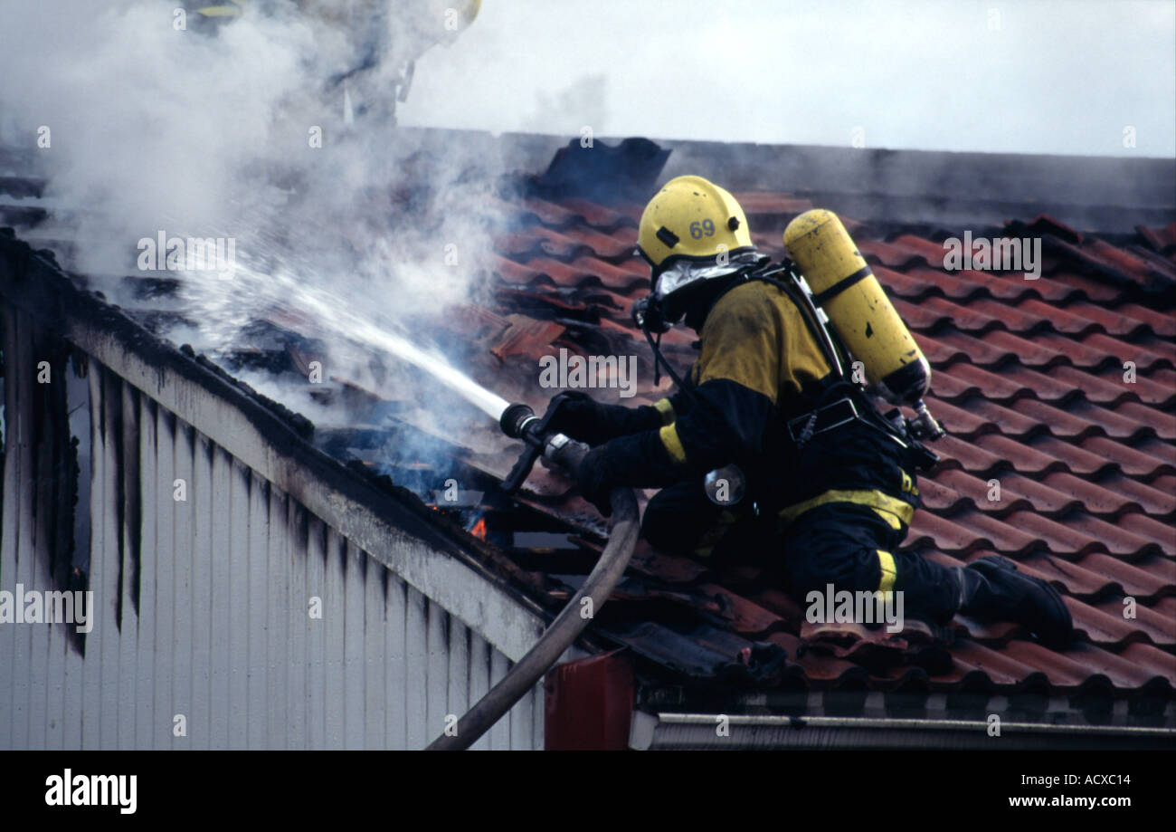 firemen tackling roof fire Stock Photo - Alamy