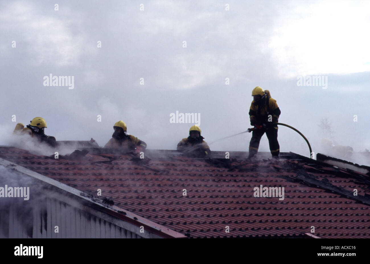 firemen tackling roof fire Stock Photo - Alamy