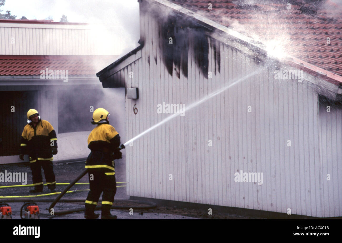 firemen tackling roof fire Stock Photo - Alamy