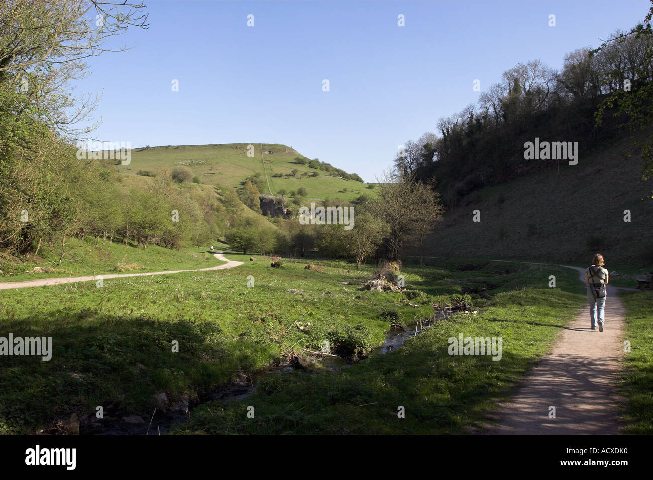 Walking along the loop pathway in Tideswell Dale in the Derbyshire Peak ...