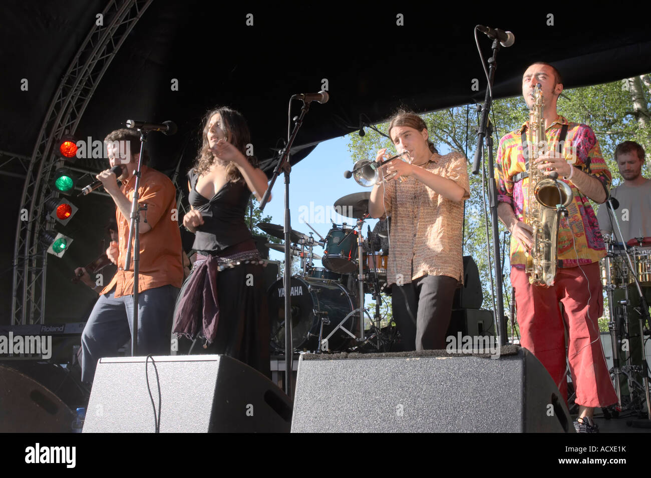 A band performing on a stage at the World Village festival, Kaisaniemi ...