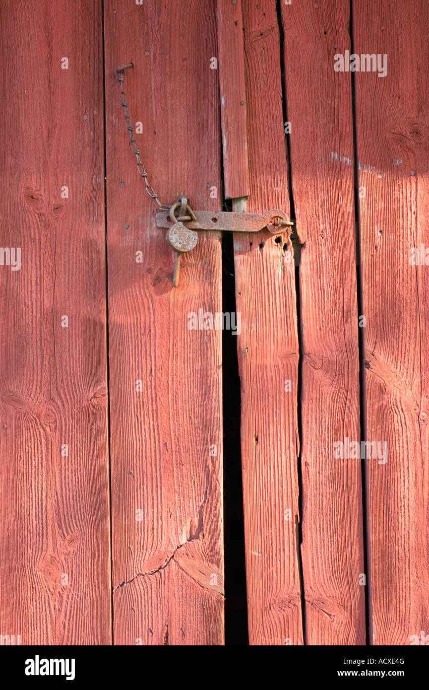 Old lock on a falu red painted wooden storehouse door at Karkali ...