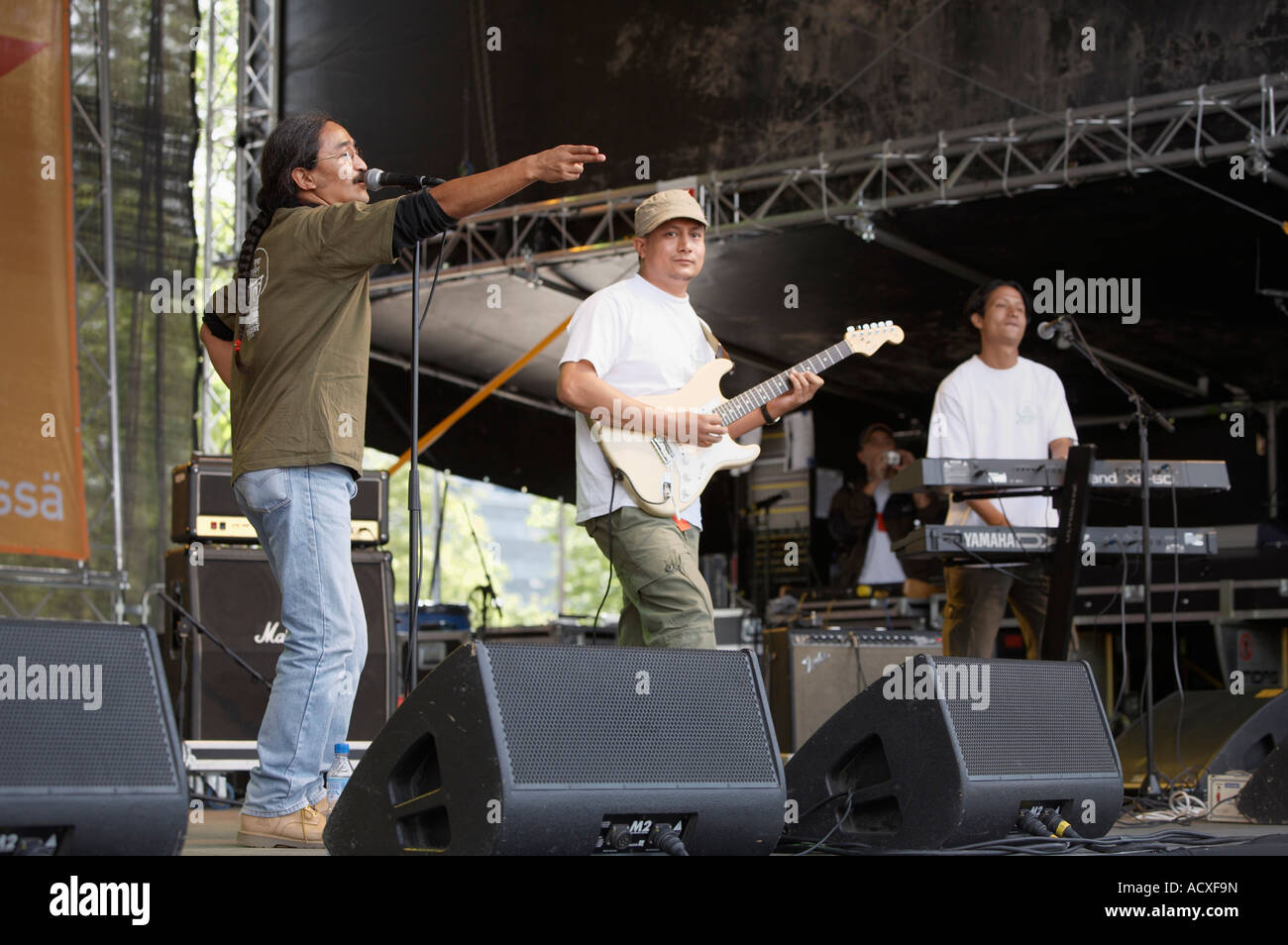 A band performing on a stage at World Village Festival at Kaisaniemi ...