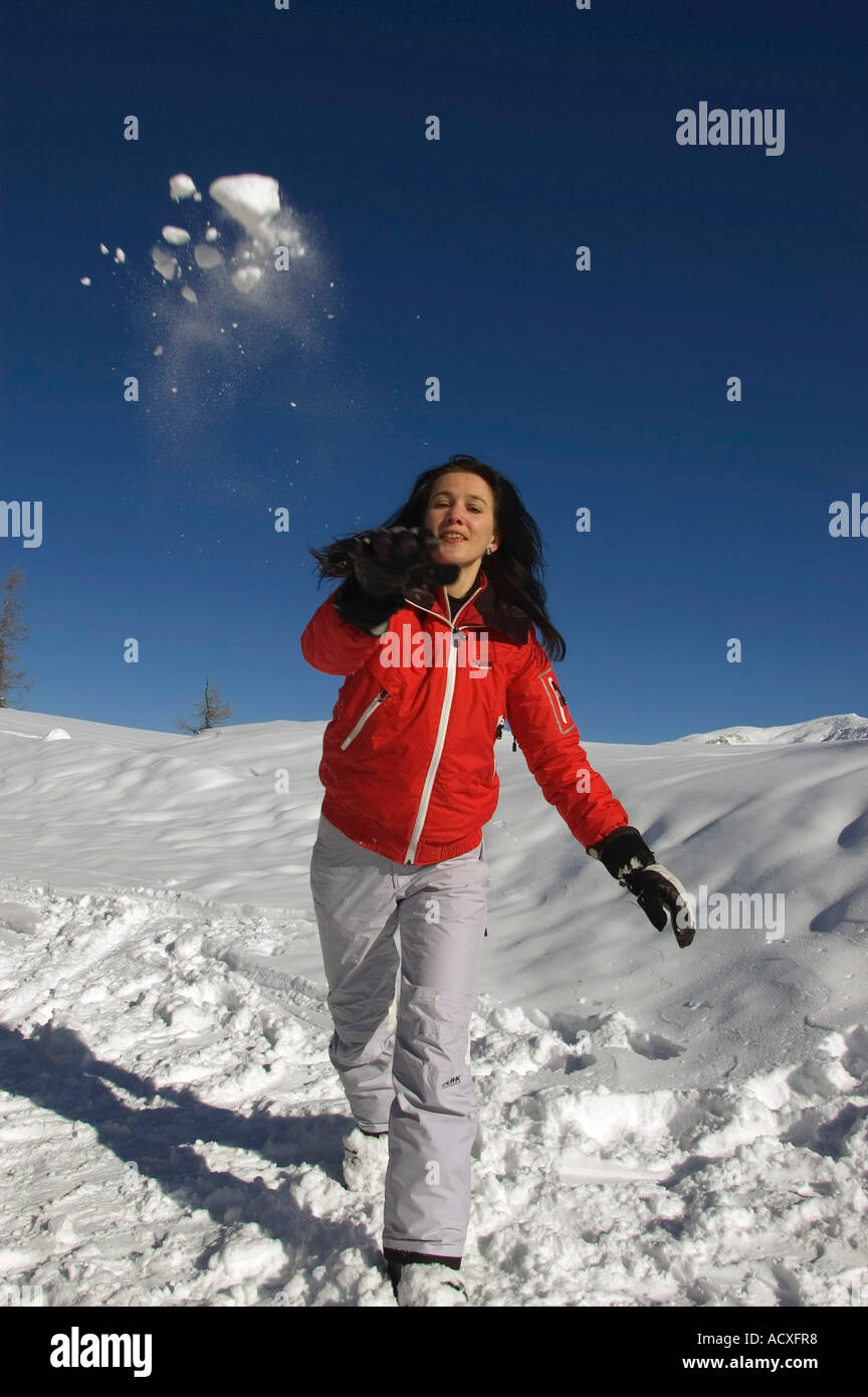Woman throwing snowball Stock Photo - Alamy