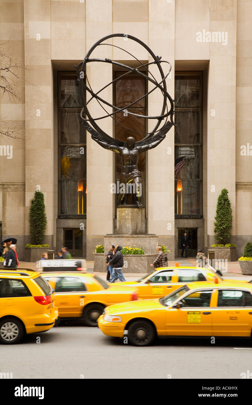Atlas and Globe outside the Rockerfeller Center with yellow taxi cabs ...