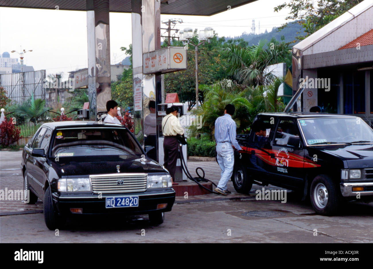 Chinese drivers fill their automobile gas tanks at gas station in ...