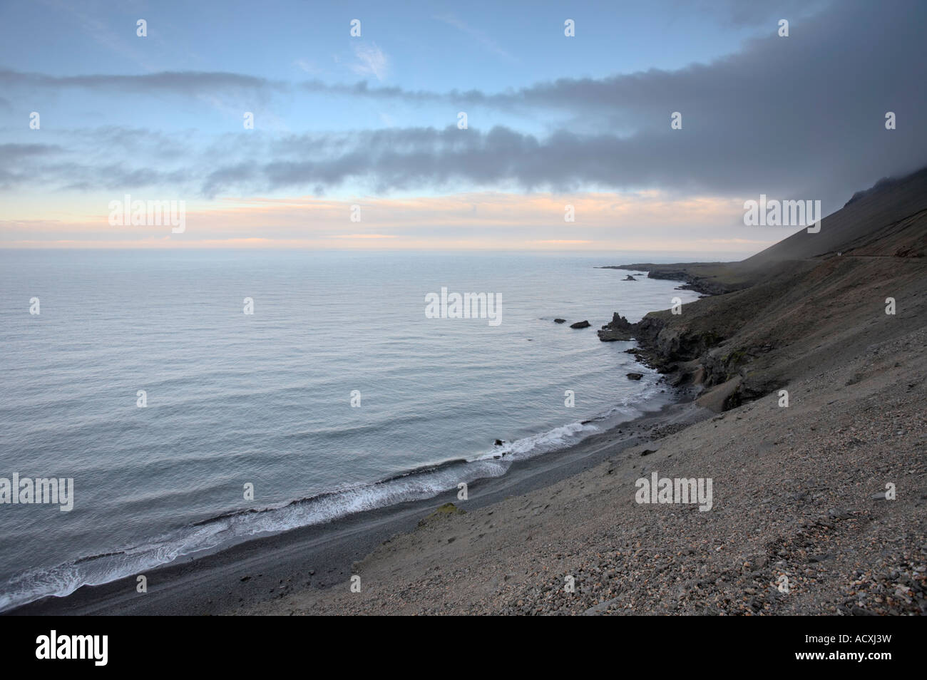 Coastal mountainside at sunset, Lonsvik bay, Iceland Stock Photo - Alamy