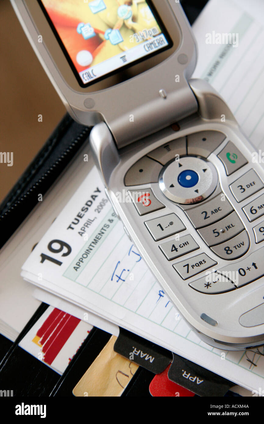 Mobile phone and agenda communication Stock Photo - Alamy