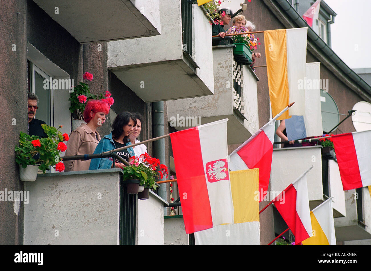 People on balconies with flags at the Feast of Corpus Christi, Poznan ...