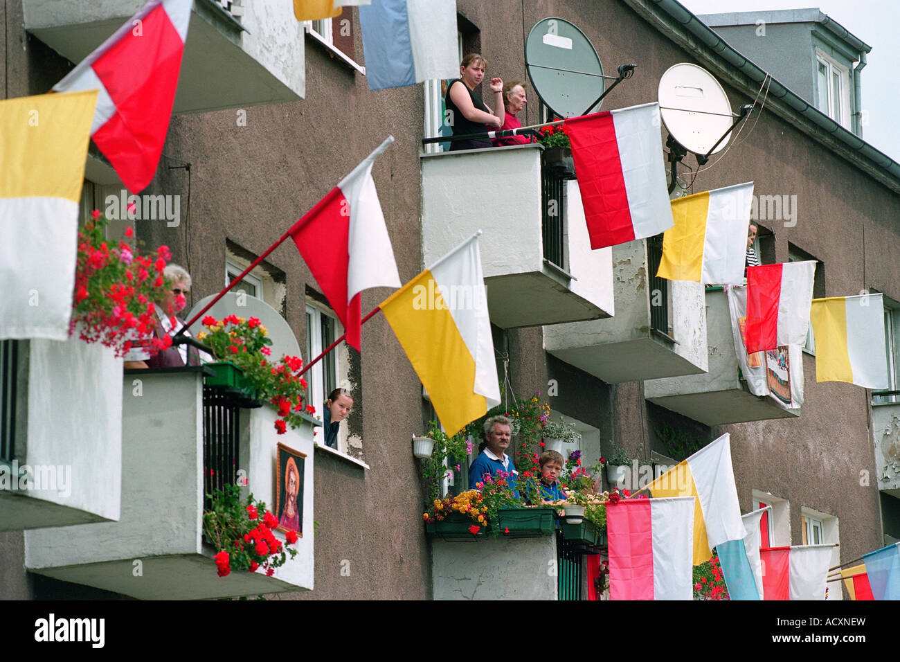 People on balconies with flags at the Feast of Corpus Christi, Poznan ...