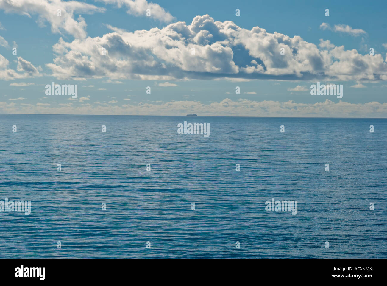a distant ship on the flat and calm deep blue tropical ocean Stock ...