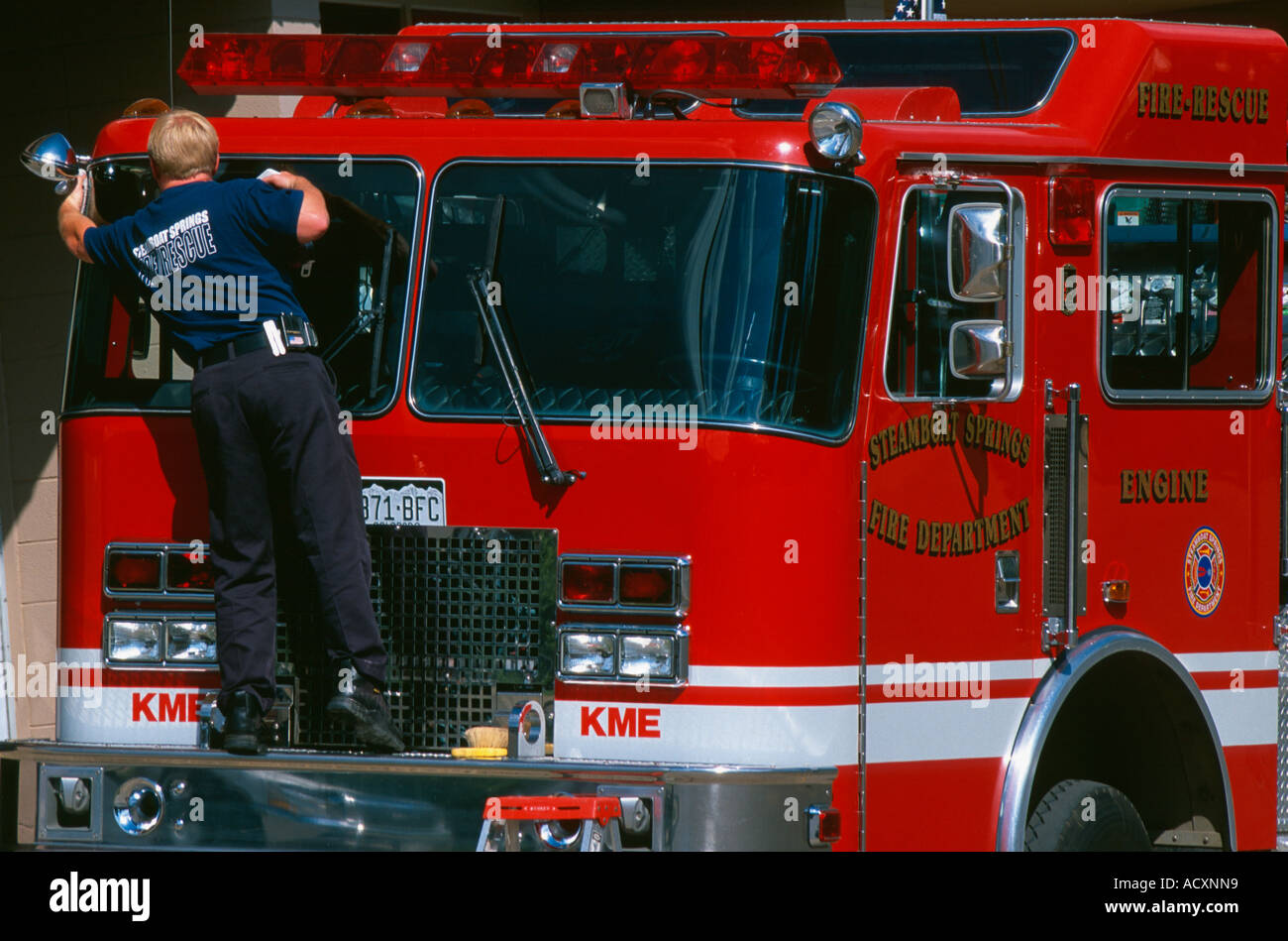 Fireman cleaning fire truck Stock Photo - Alamy