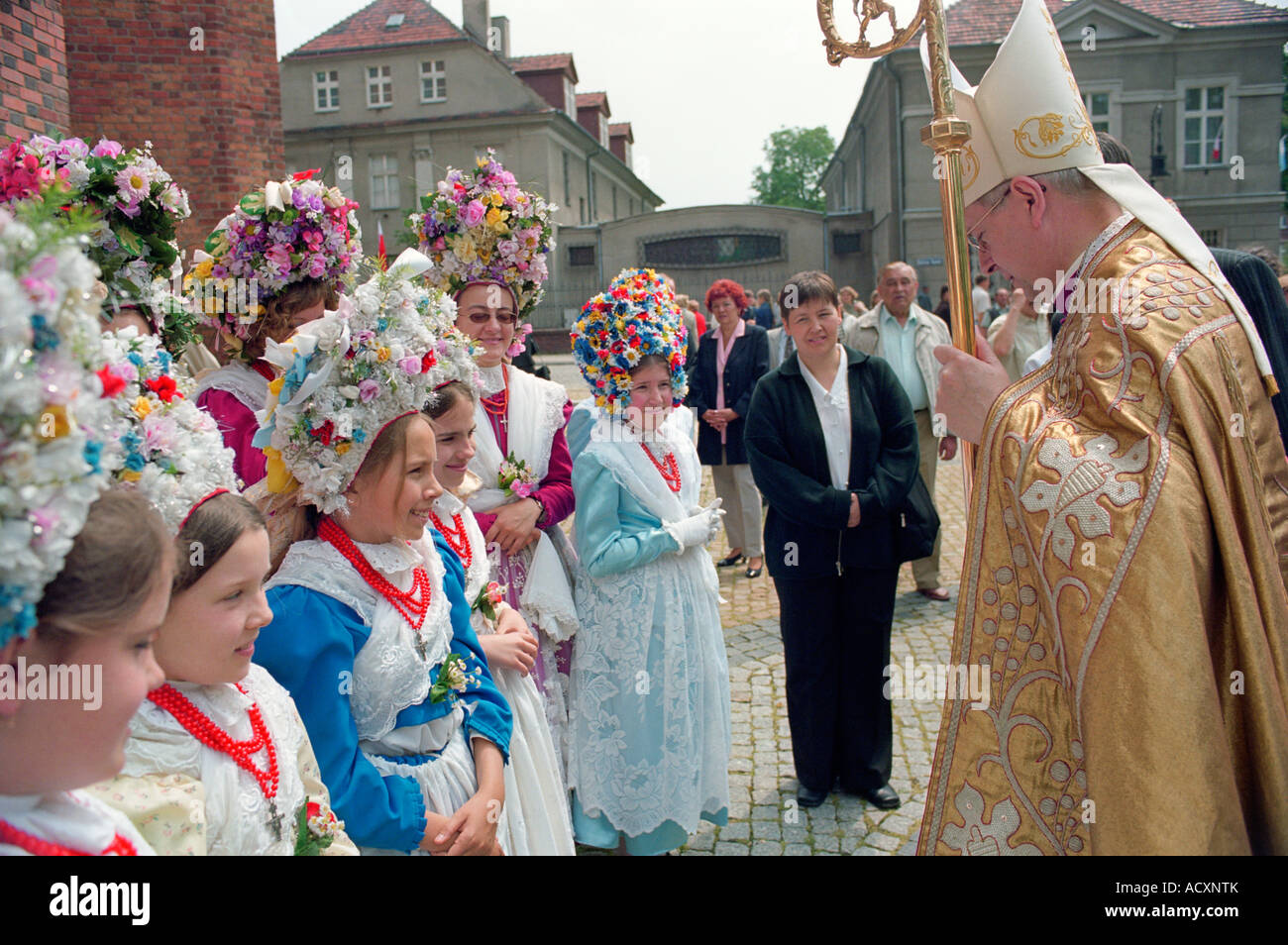 The archbishop of Poznan talking to girls in traditional costumes ...