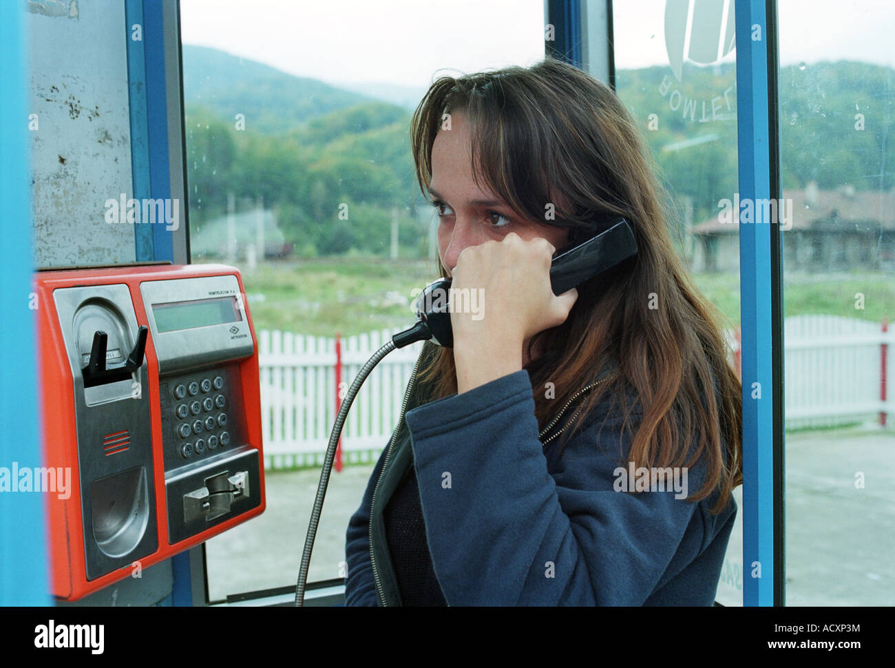 Woman in a phone booth, Udricani, Romania Stock Photo - Alamy
