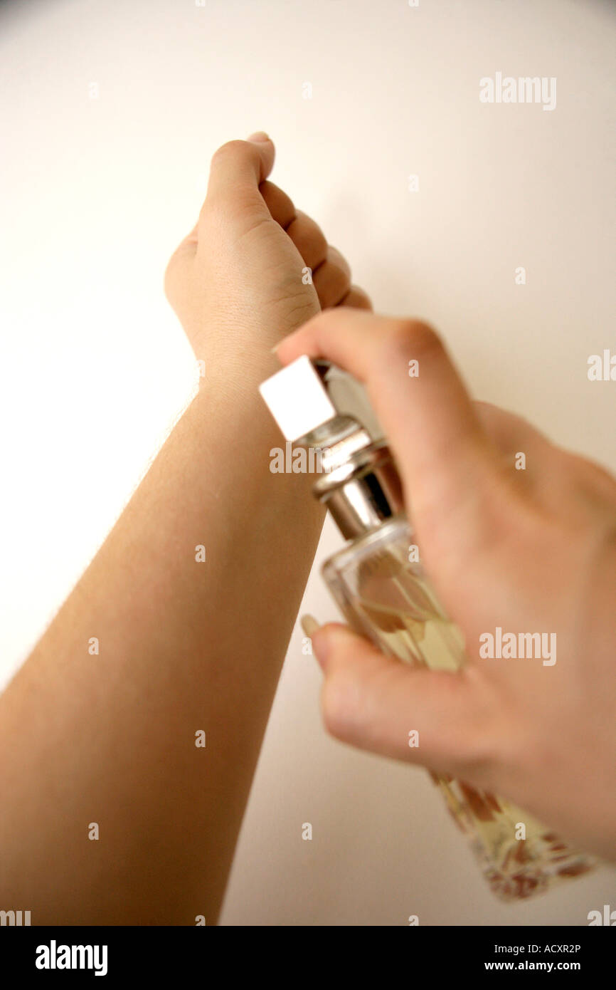 Spraying perfume on the wrist Stock Photo - Alamy