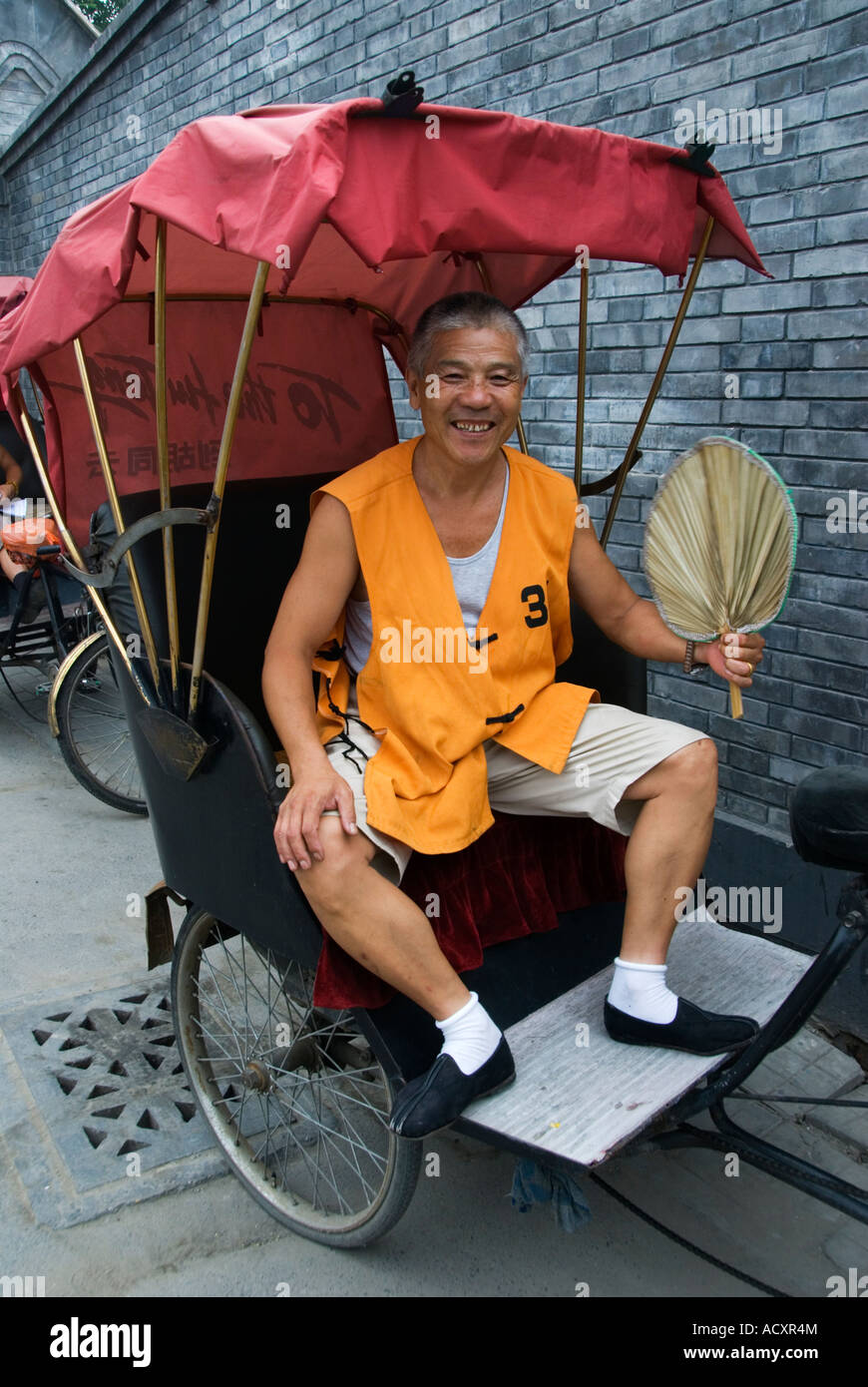 Rickshaw driver poses in Beijing hutong 2007 Stock Photo - Alamy