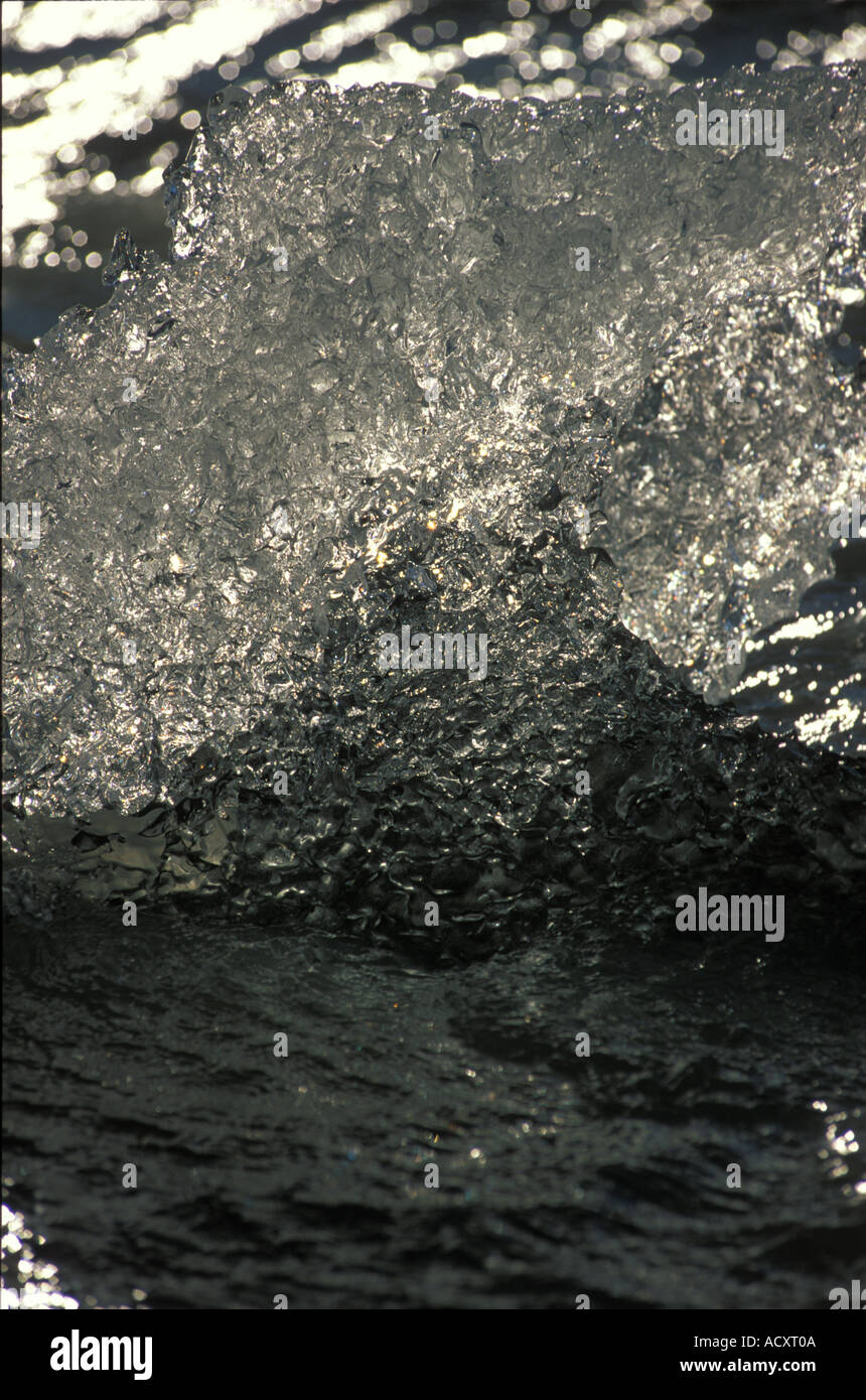 Lump of ice sculpted by natural elements into interesting form floating ...