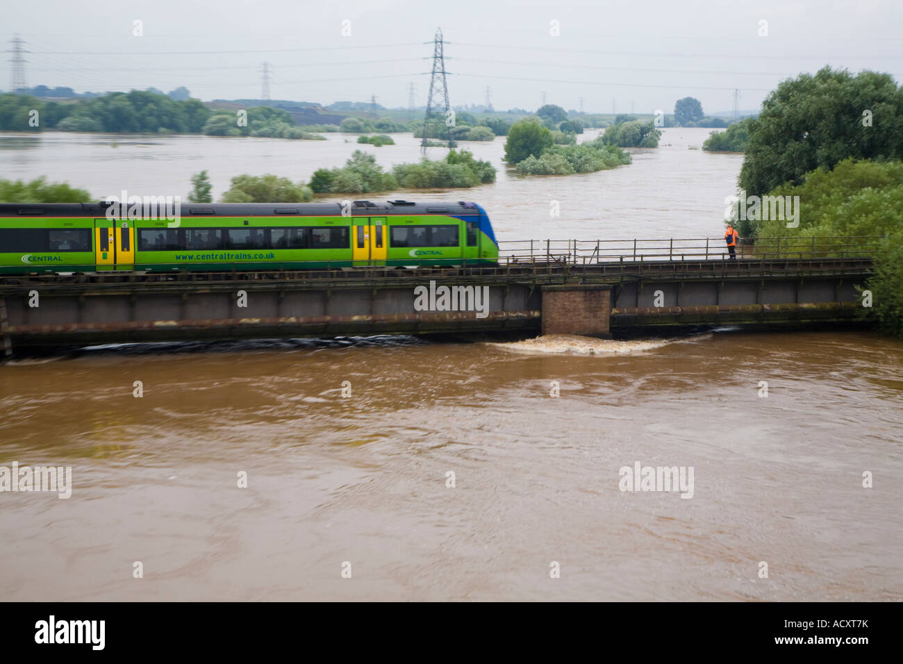 train going over bridge on the flooded river severn in gloucester uk ...