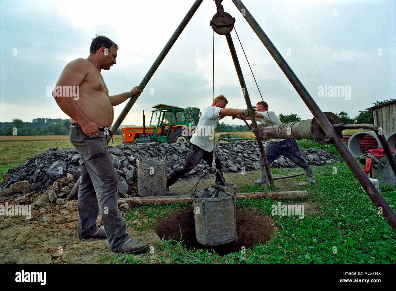 Men digging a well, Poland Stock Photo - Alamy