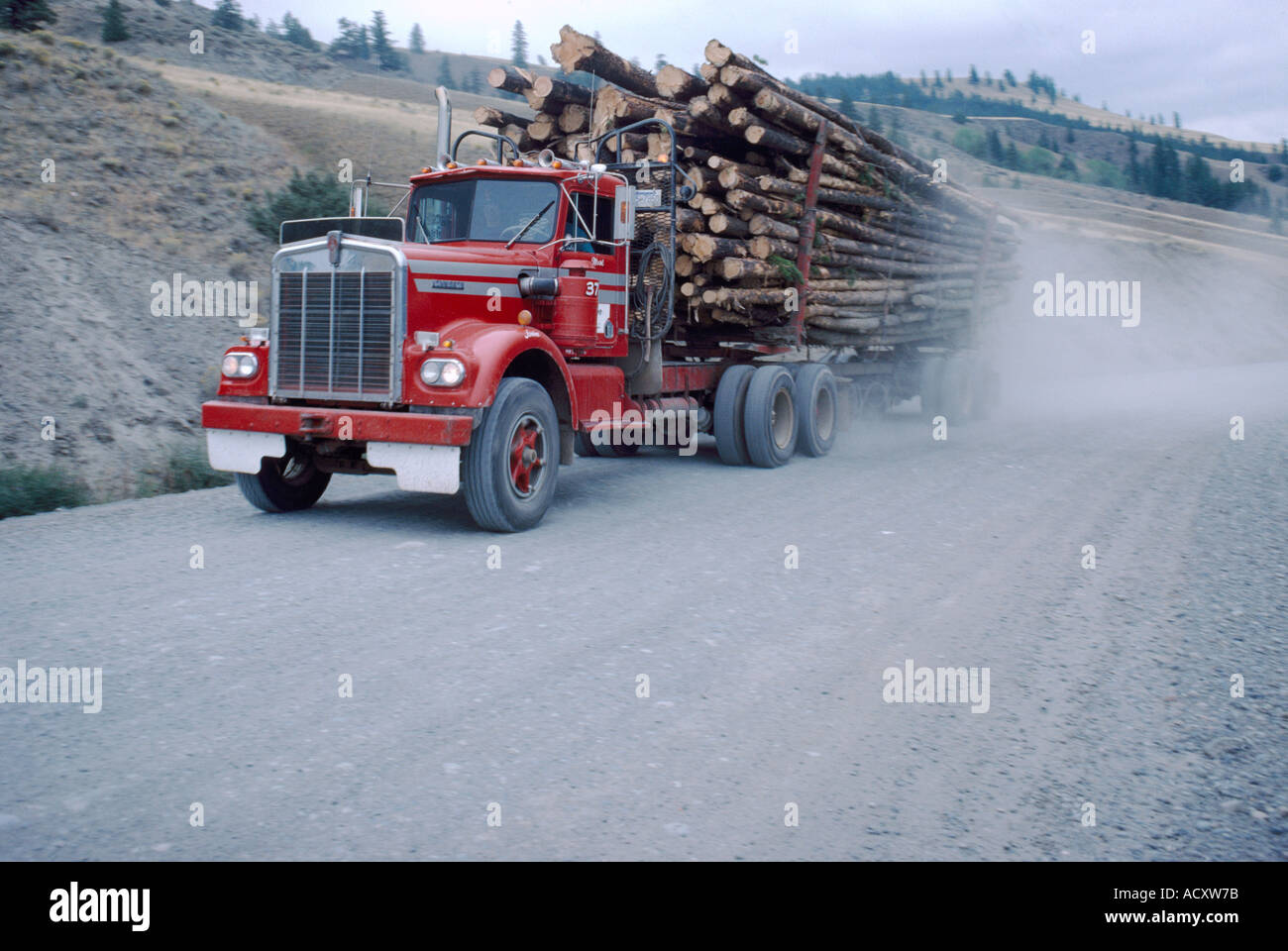 A Loaded Logging Truck travelling on a Dirt Road in the Cariboo Region ...