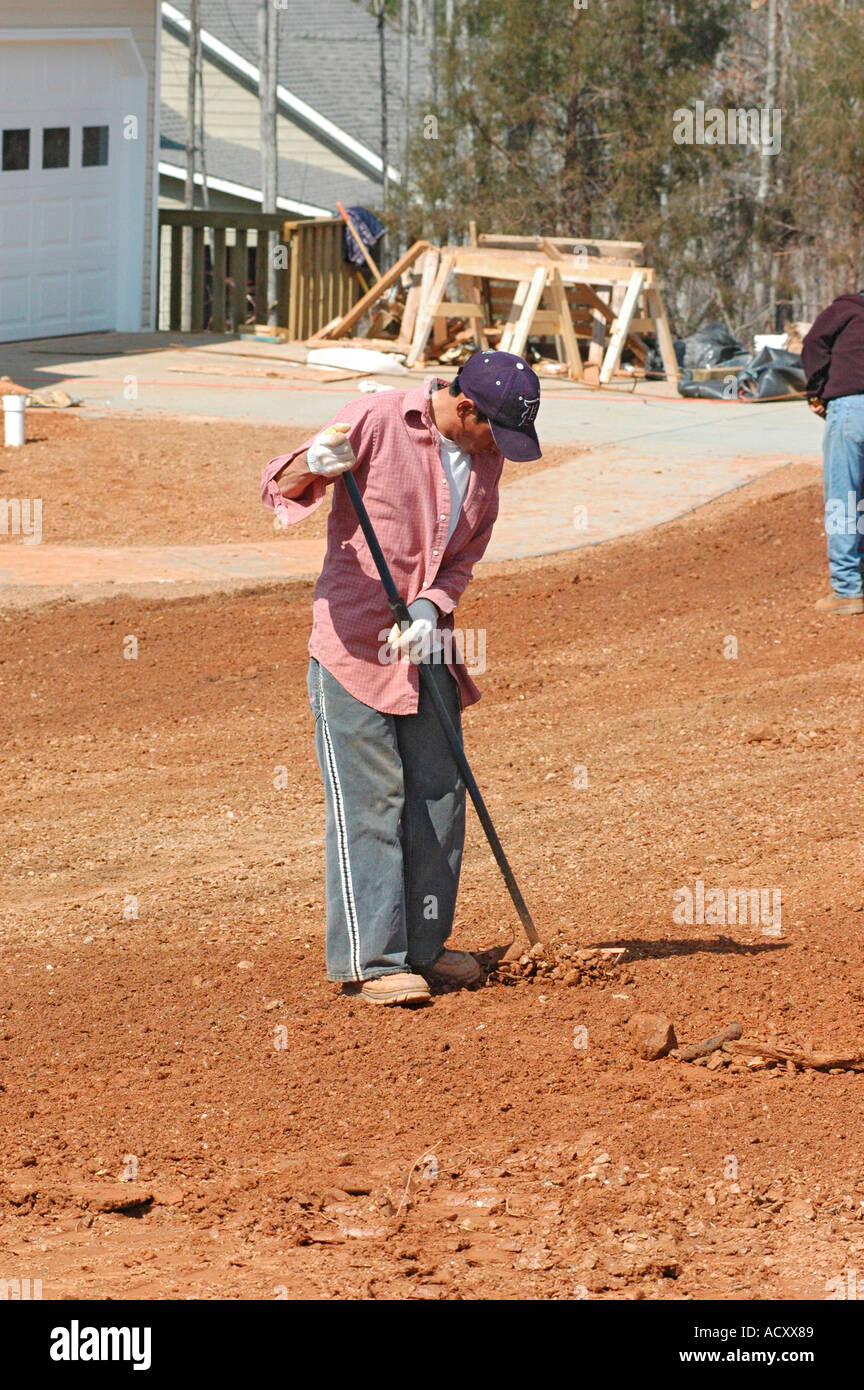 Getting yard ready for grass sod with rakes and rock hound on tractor ...