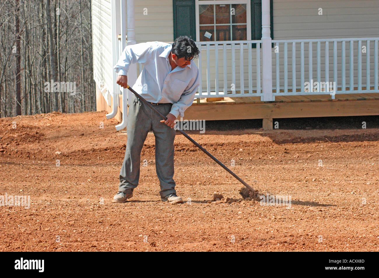 Getting yard ready for grass sod with rakes and rock hound on tractor ...