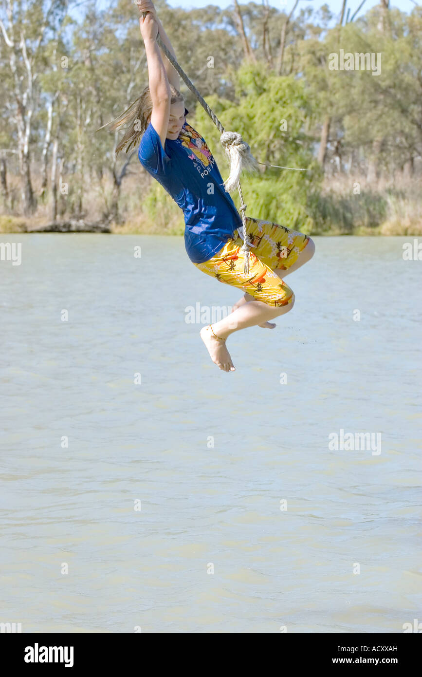 Child swinging rope river water hi-res stock photography and images - Alamy