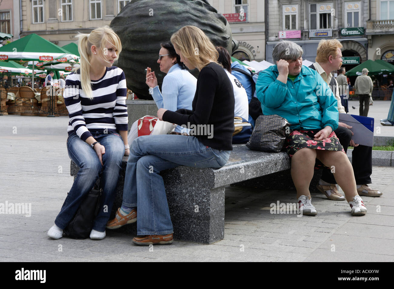 People sitting in the Main Market Square in Cracow, Poland Stock Photo ...