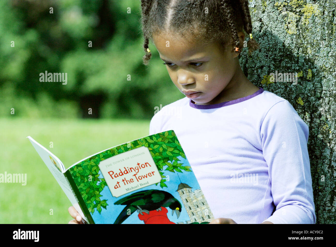 Girl reading book Stock Photo - Alamy