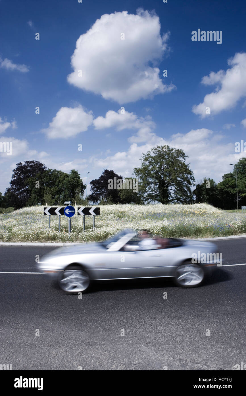 Sports car on roundabout Stock Photo - Alamy
