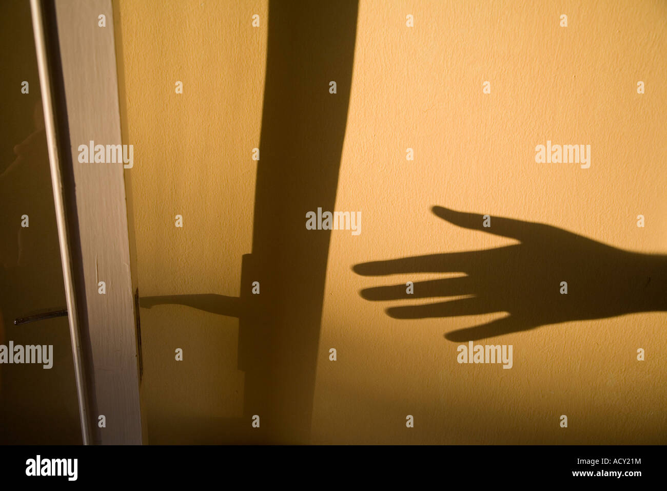 Shadow of a hand reaching for the door Stock Photo - Alamy