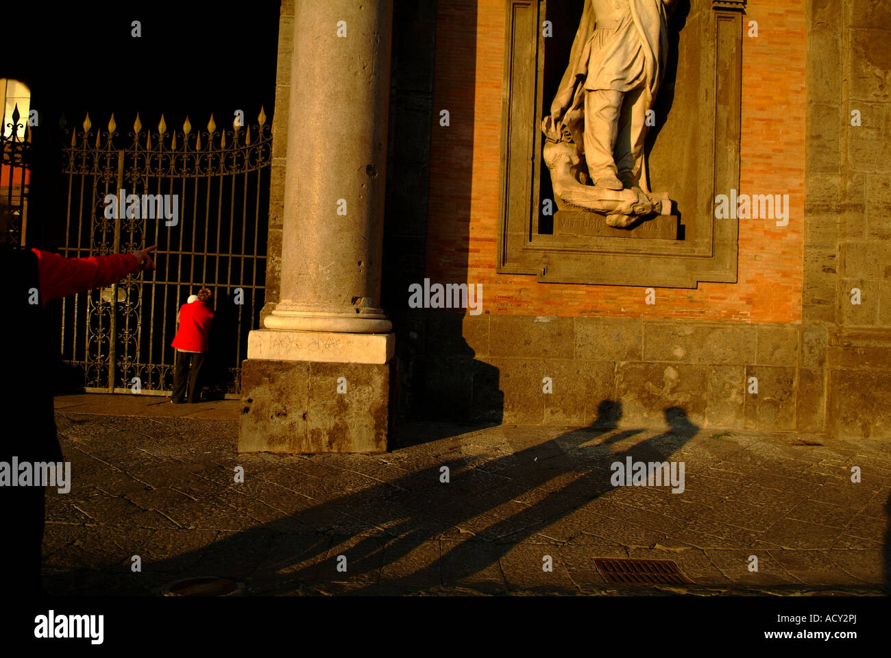 pointing at a statue, naples, italy Stock Photo - Alamy
