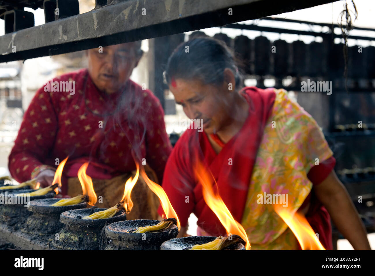 Nepali women lighting butter lamps.Swayambhunath Stupa.Kathamandu.Nepal ...