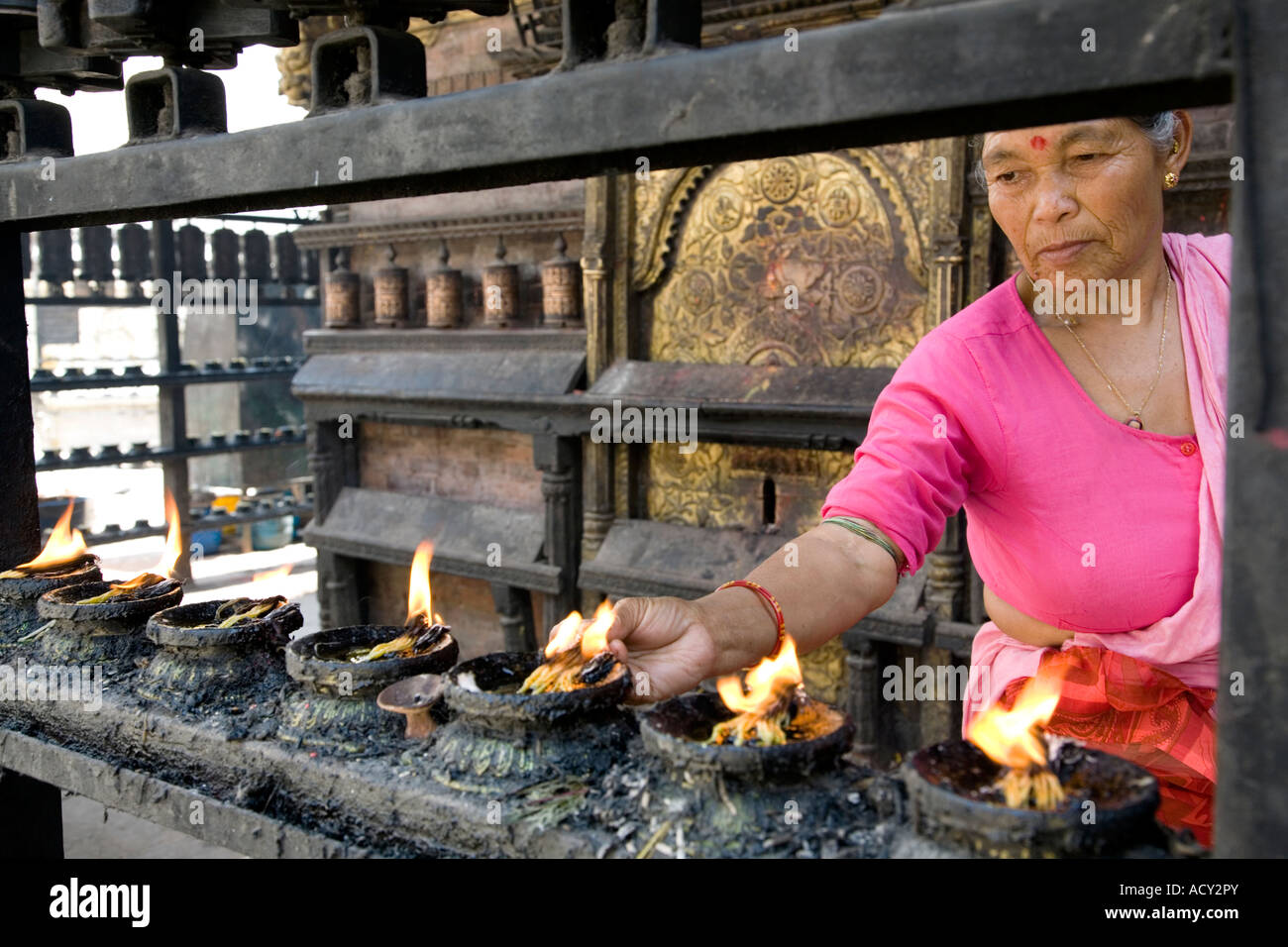 Nepali woman lighting butter lamps.Swayambhunath Stupa.Kathamandu.Nepal ...