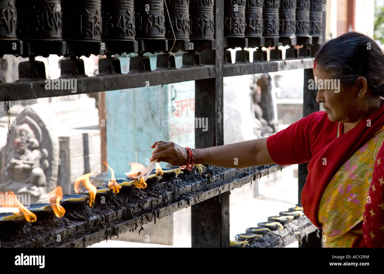 Nepali woman lighting butter lamps.Swayambhunath Stupa.Kathmandu.Nepal ...