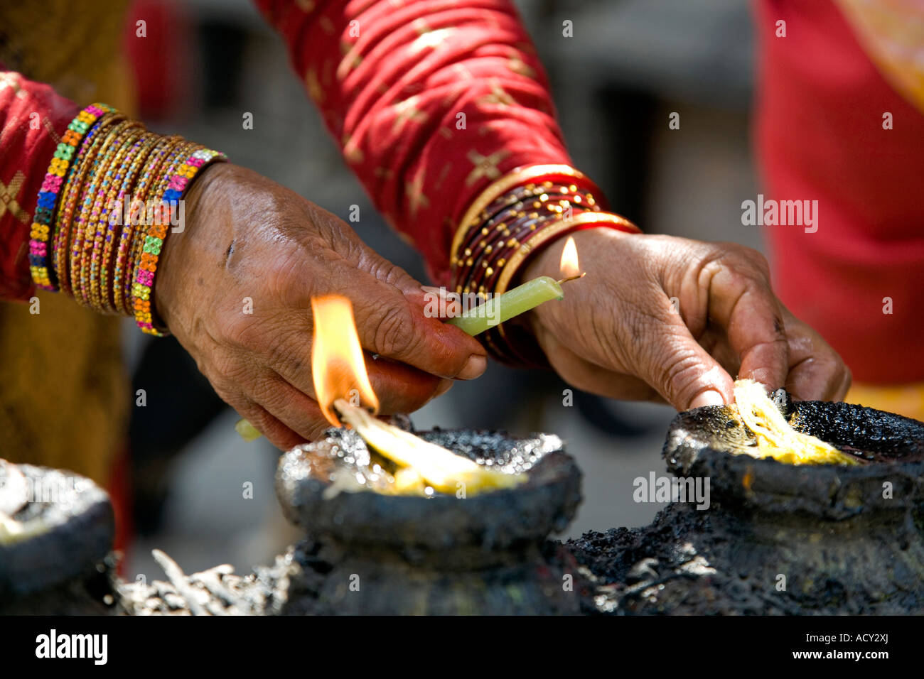 Nepali woman lighting butter lamps.Swayambhunath Stupa.Kathmandu.Nepal ...