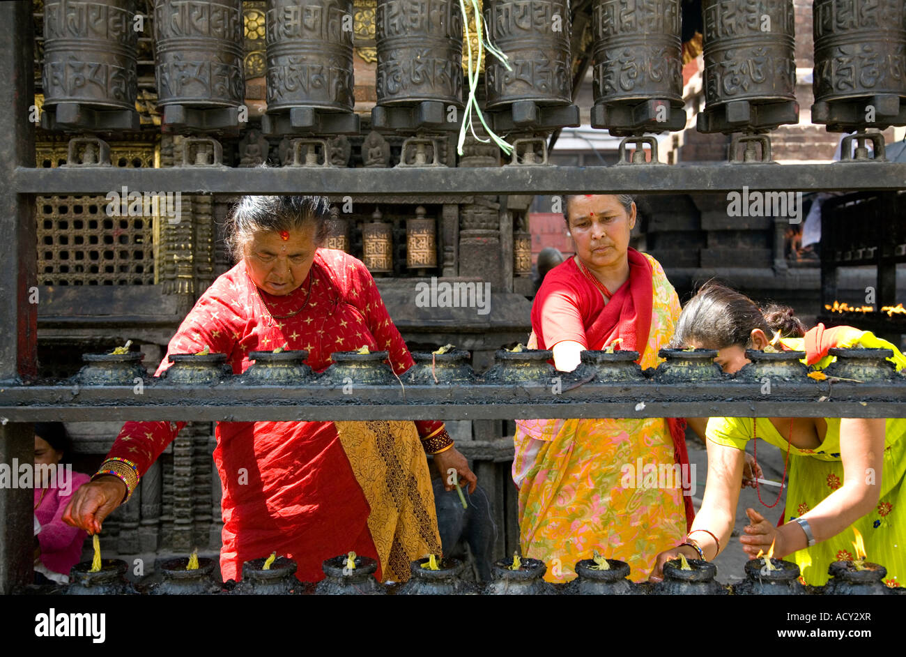 Nepali women lighting offering butter lamps.Swayambhunath Stupa ...