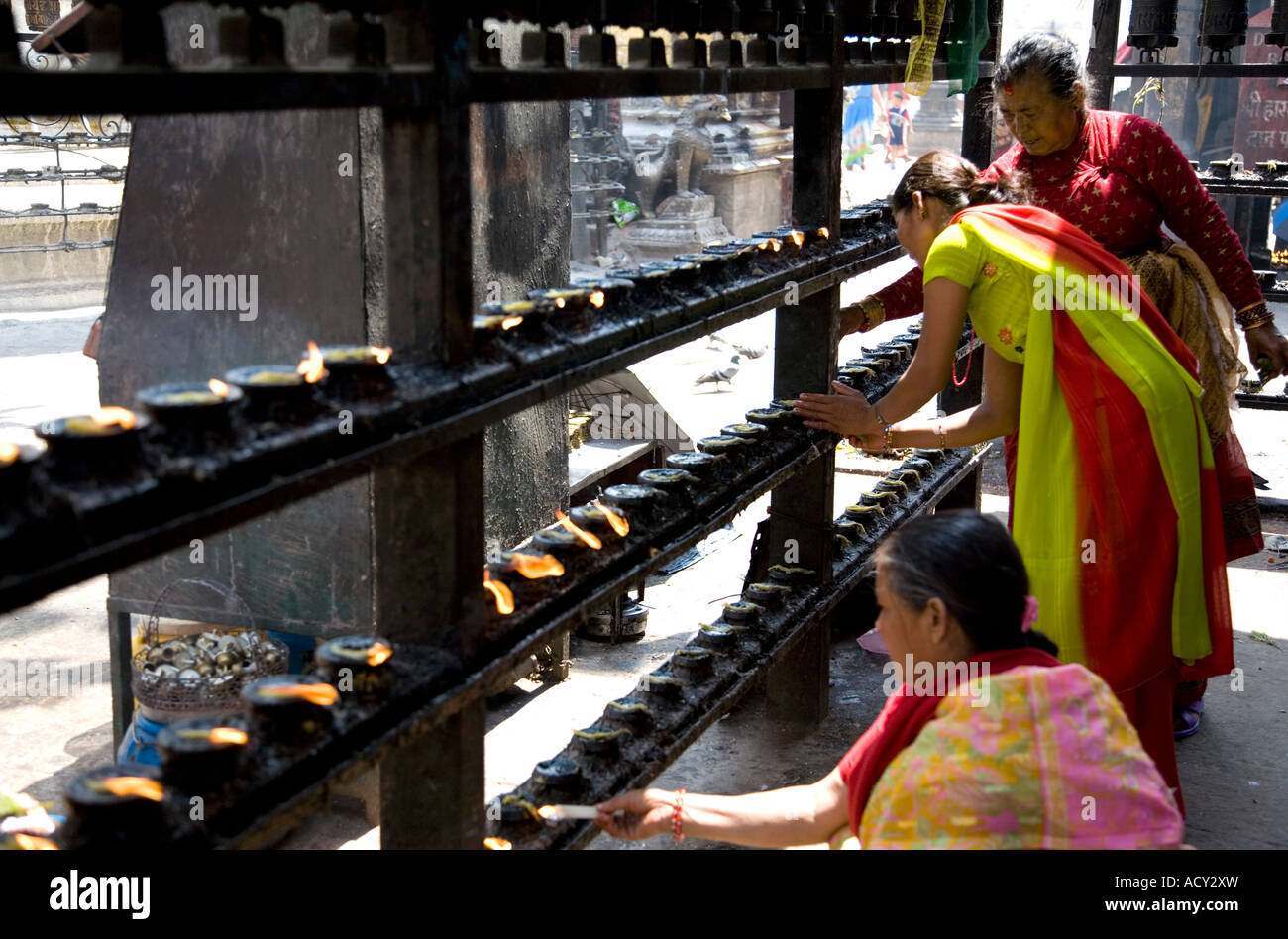 Nepali women lighting offering butter lamps.Swayambhunath Stupa ...