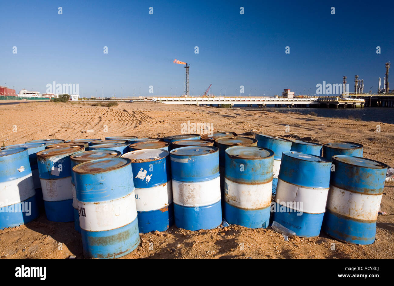 Fuel barrels and a refinery burner in Huelva, Spain Stock Photo - Alamy